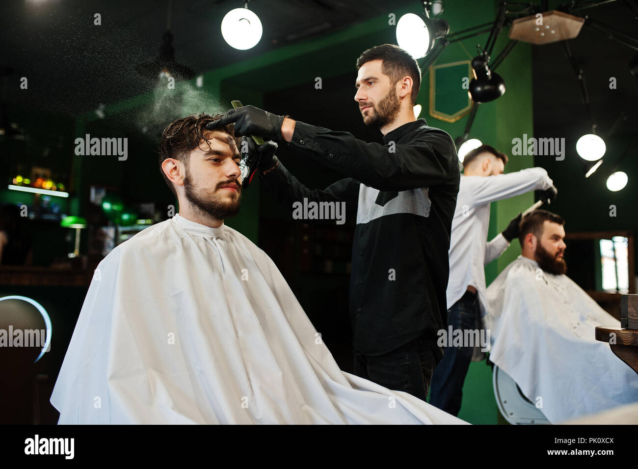 Handsome bearded man at the barbershop, barber at work Stock Photo - Alamy