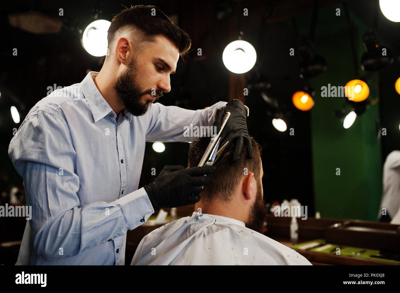 Handsome bearded man at the barbershop, barber at work Stock Photo - Alamy