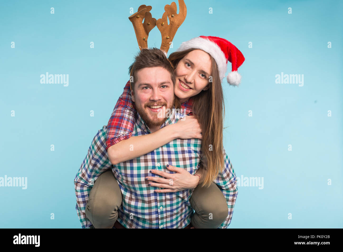 People, holidays and christmas concept - young couple in christmas ...