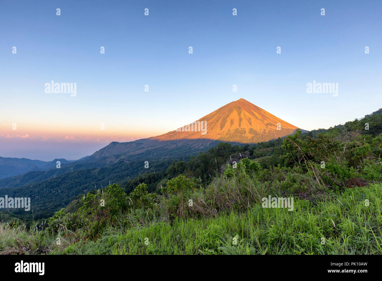 Early morning view of light hitting Mount Inerie, a volcano in Flores ...