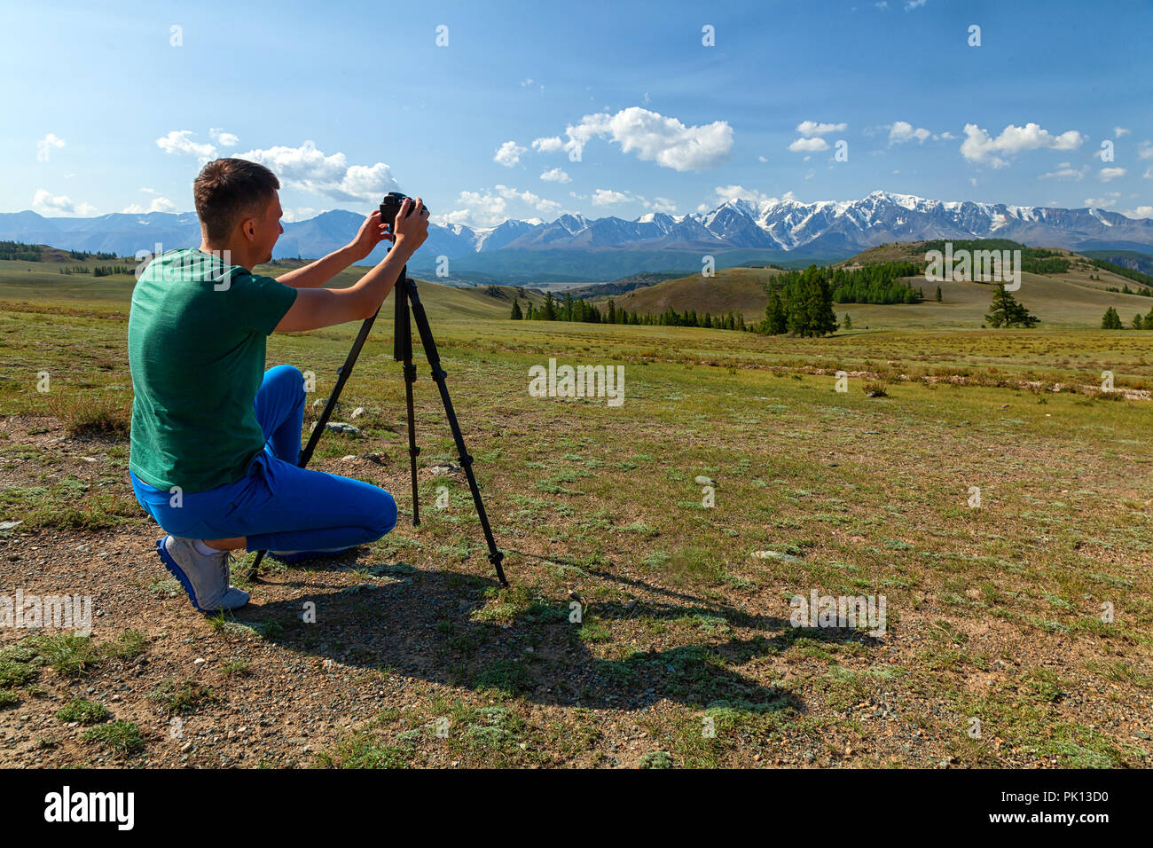 Travel hiking man shoooting mountain landscape. Tourist professional ...