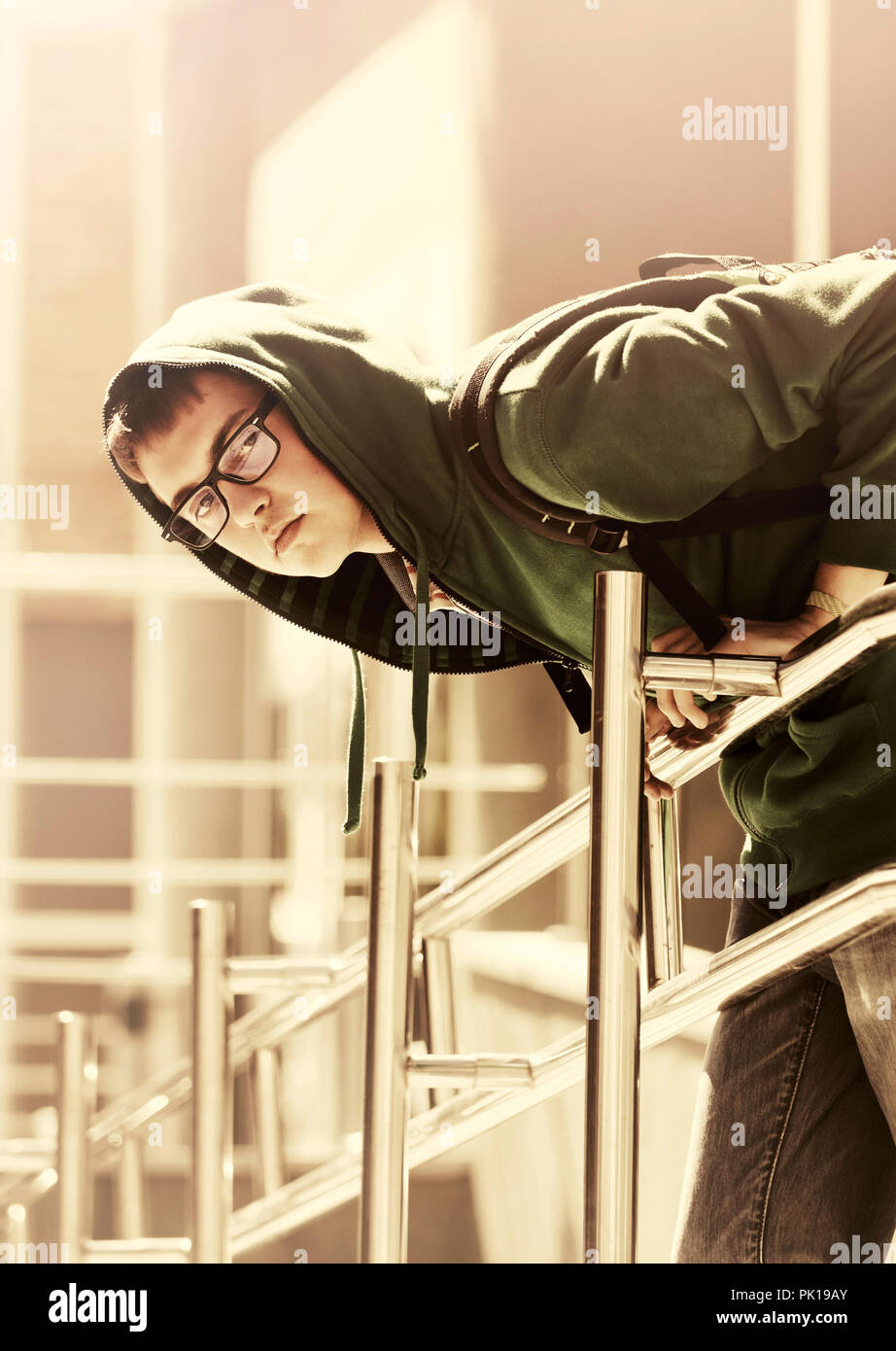 Teen boy with backpack against a school building Stock Photo - Alamy