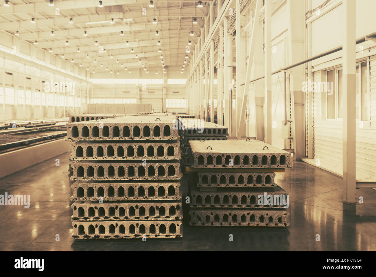Stack of precast reinforced concrete slabs in a house-building factory ...