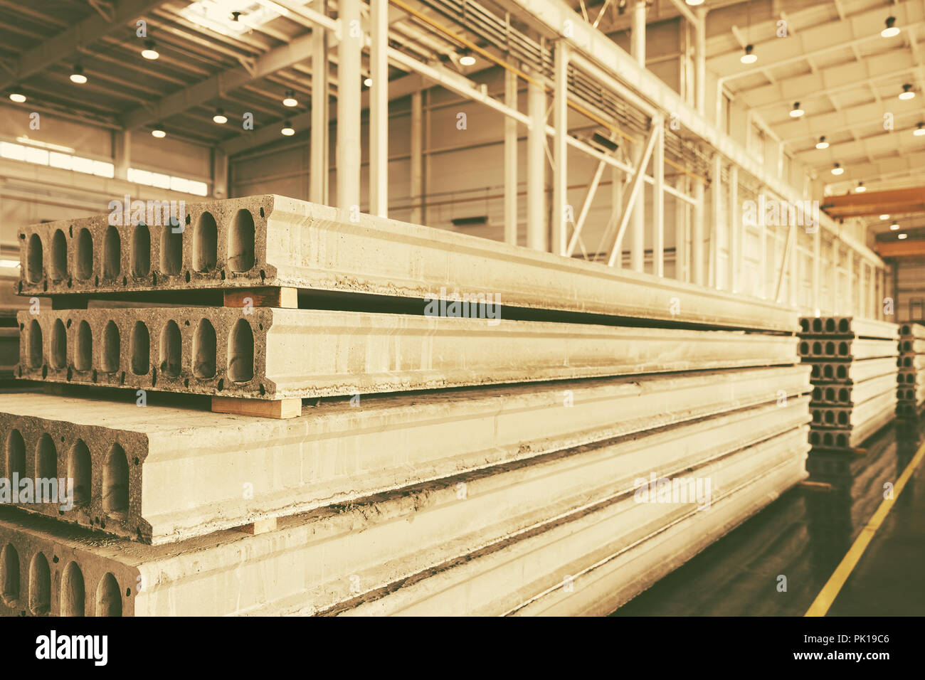 Stack of precast reinforced concrete slabs in a house-building factory ...