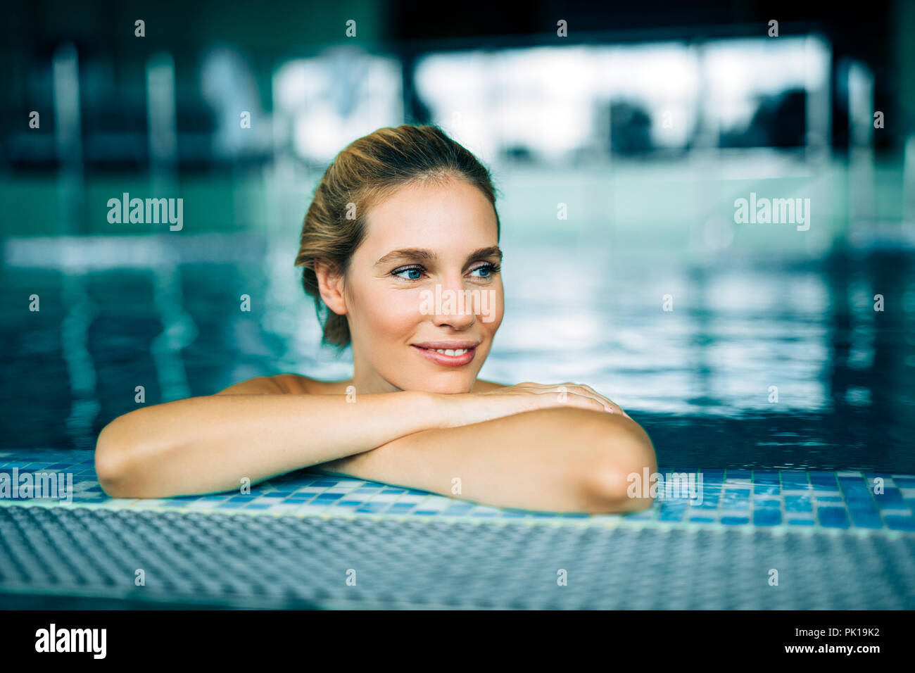Portrait of beautiful woman relaxing in swimming pool Stock Photo - Alamy