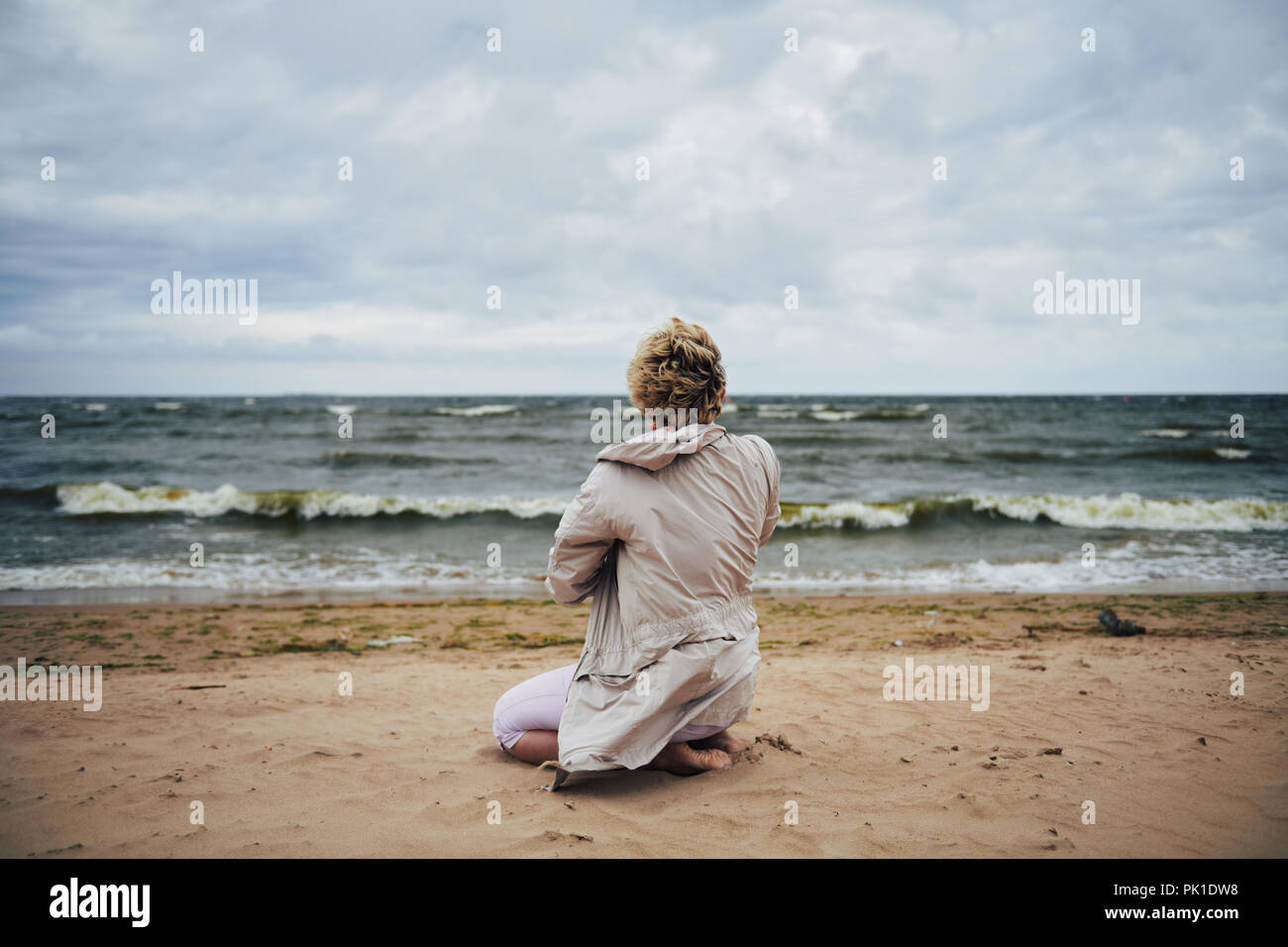 Anonymous woman in jacket looking at sea Stock Photo - Alamy