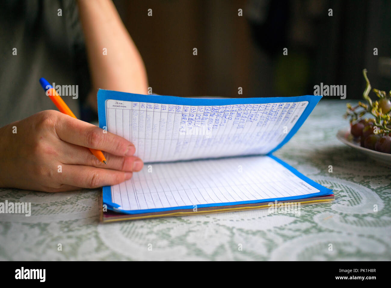 Studing human writing writing in a notebook Stock Photo - Alamy