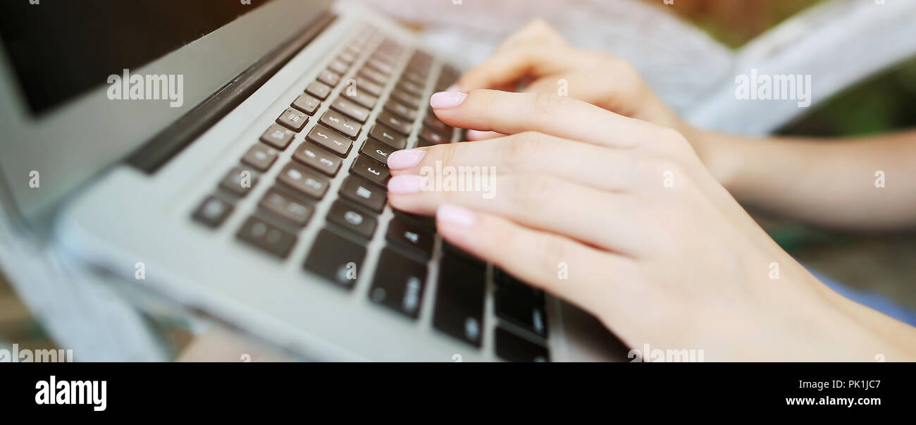 Website header and banner of closeup female hands typing on laptop ...