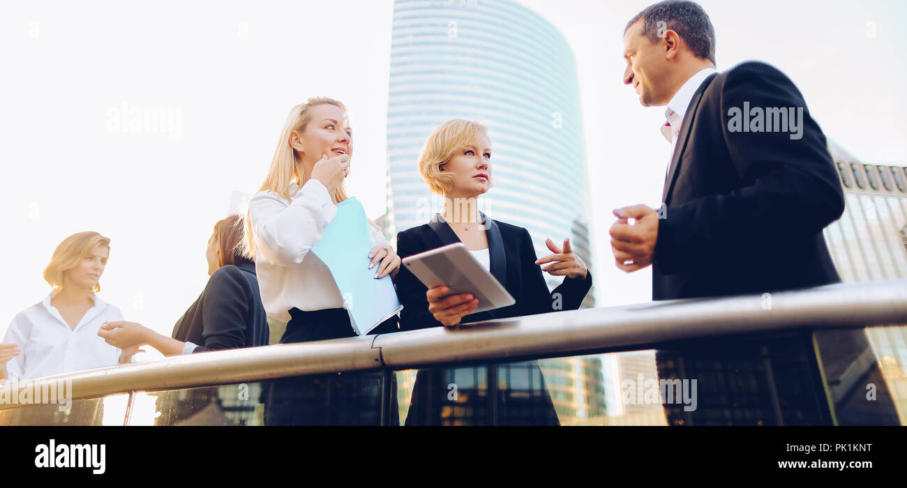Happy business team members talking outside in Stock Photo - Alamy