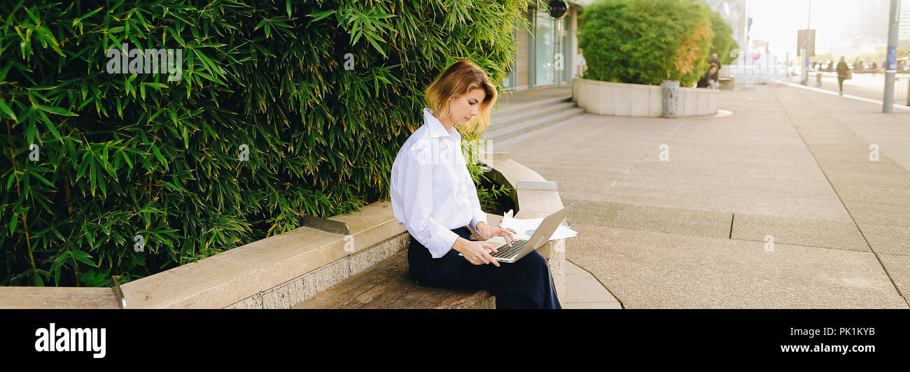 Statistician working outside with laptop and color diagrams Stock Photo ...