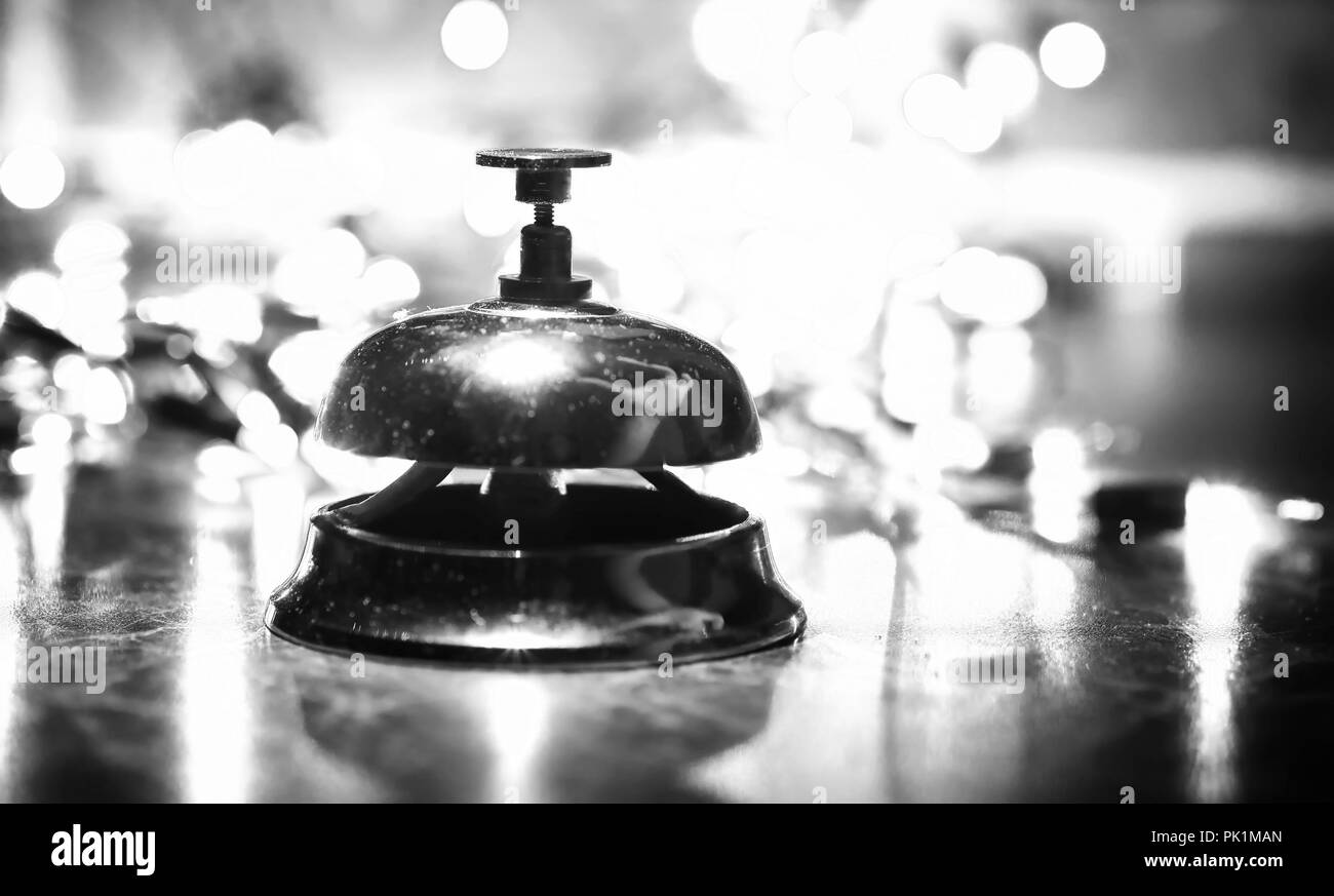 reception bell on the table and shining garland background Stock Photo ...