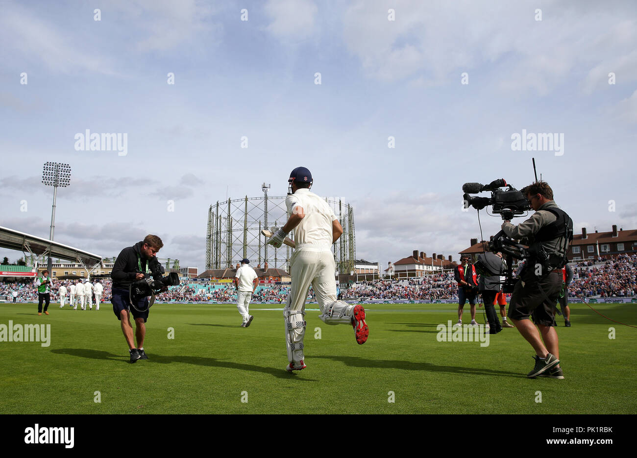 England's Alastair Cook runs out onto the field to a standing ovation ...