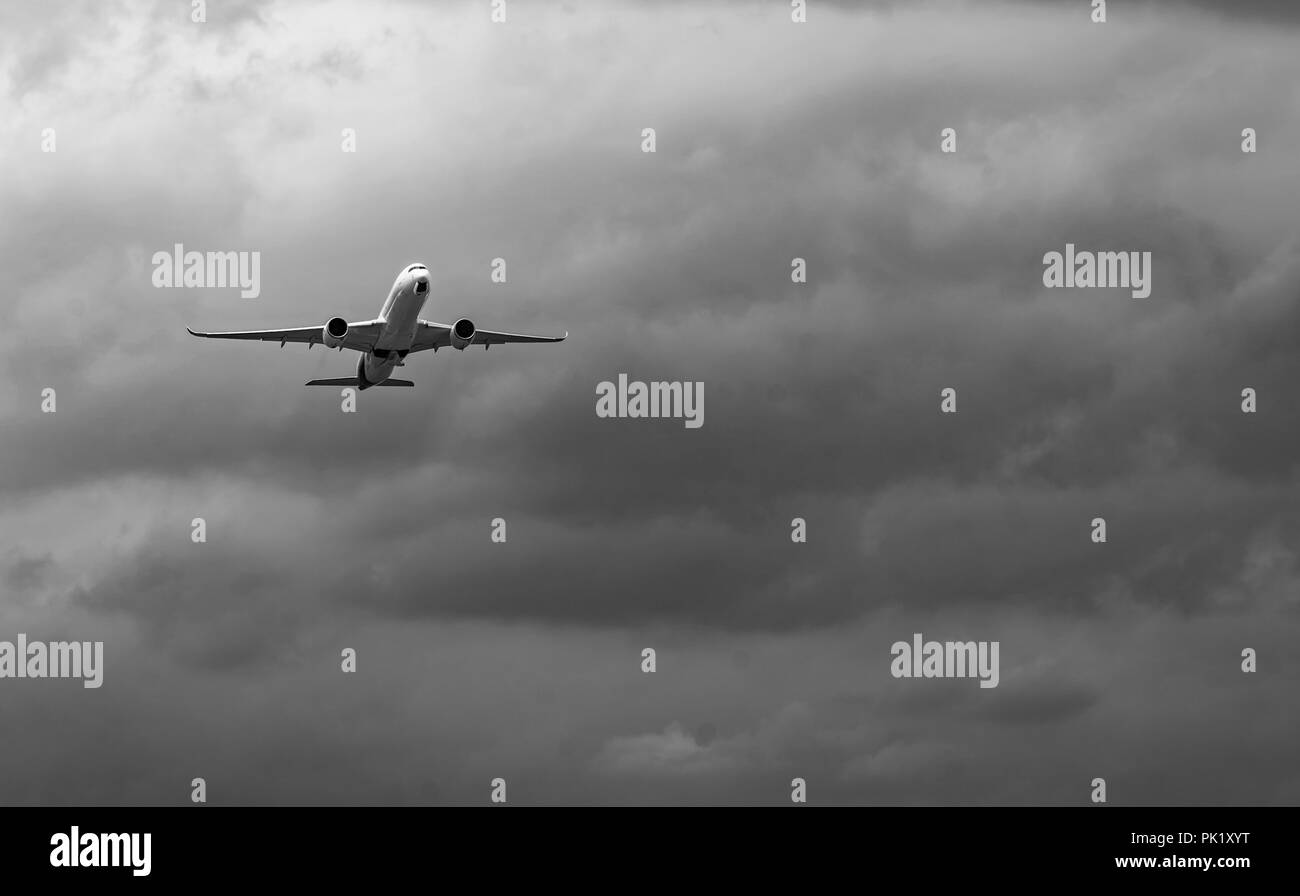 Commercial airplane on grey sky and clouds with copy space. Failed ...