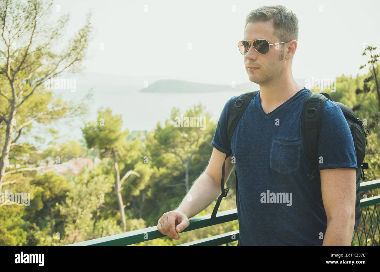 Male tourist with big rucksack on the hill Stock Photo - Alamy