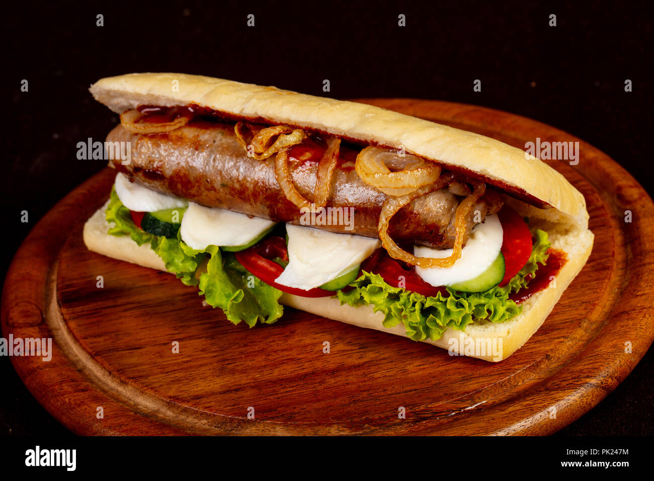 Panini with grilled sausages and cheese Stock Photo - Alamy