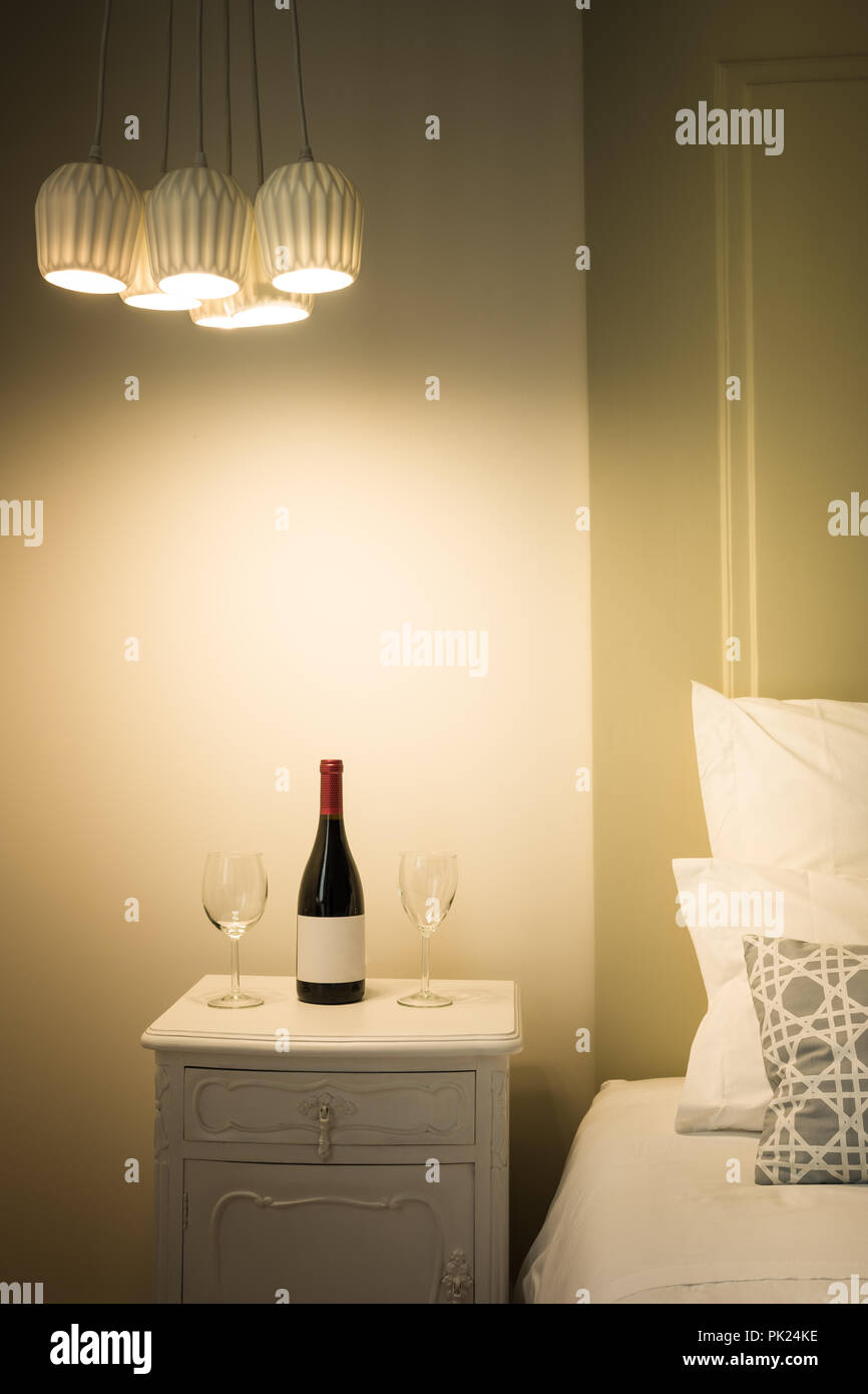 Wine bottle with wine glasses in a bedroom. Room service at the hotel ...