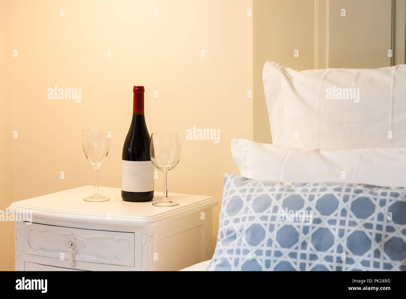 Wine bottle with wine glasses in a bedroom. Room service at the hotel ...