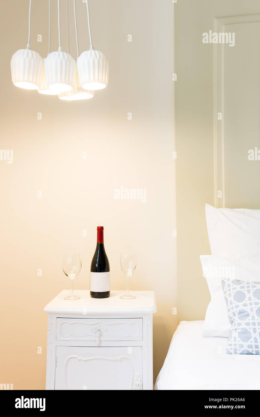 Wine bottle with wine glasses in a bedroom. Room service at the hotel ...