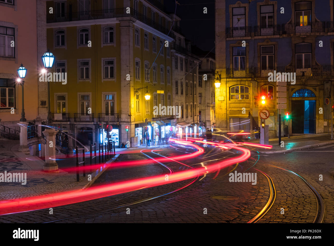 Illuminated street of old european town at night Stock Photo - Alamy