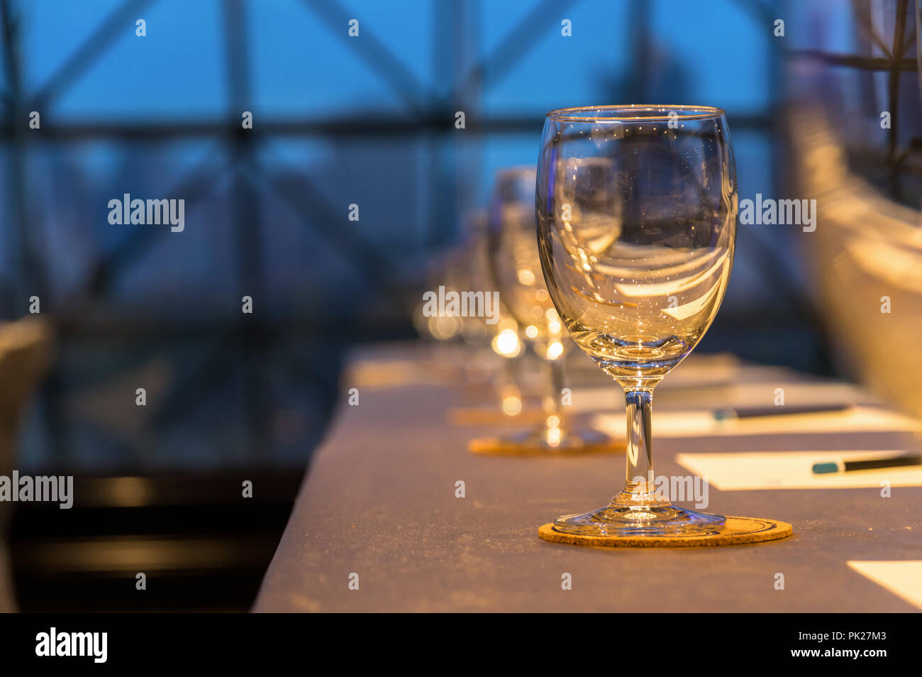 workplace with Glass of water, paper and pencil on the table in the ...