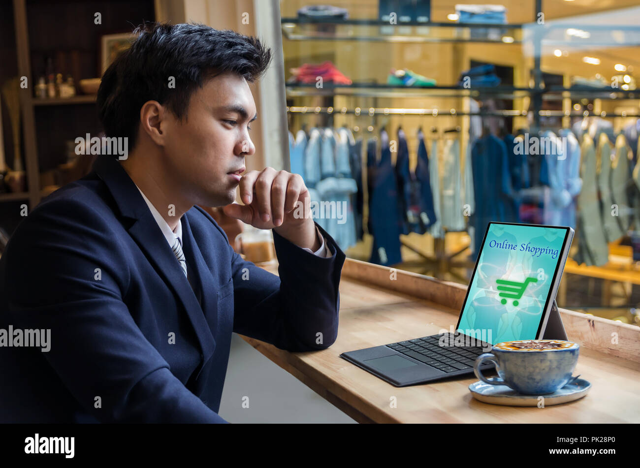 Businessman sitting and using computer laptop showing the shopping ...