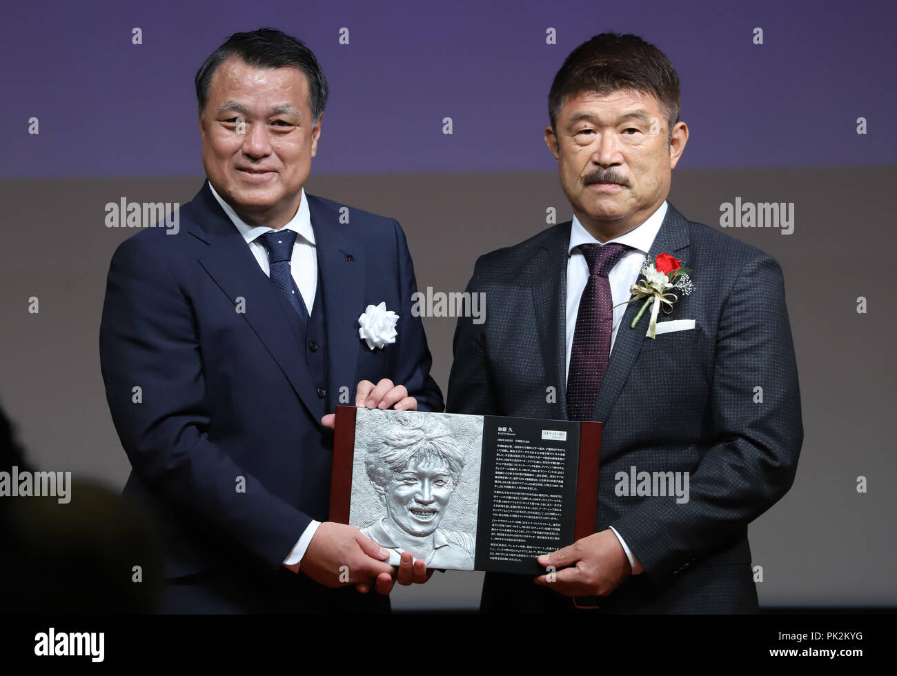 Tokyo, Japan. 10th Sep, 2018. Japanese football legend Hisashi Kato (R) receives his reliefphoto ...