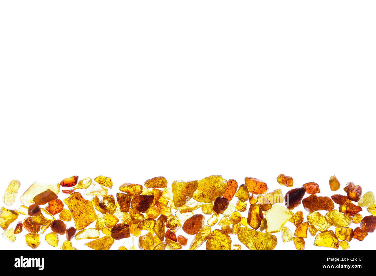 Amber abstract background made of small pieces lying at the bottom ...