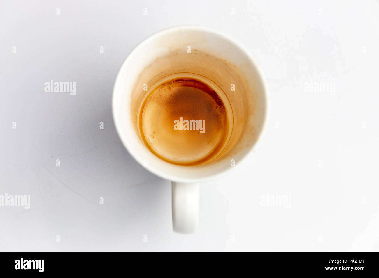 A close up top view on a dirty coffee mug on a isolated white ...