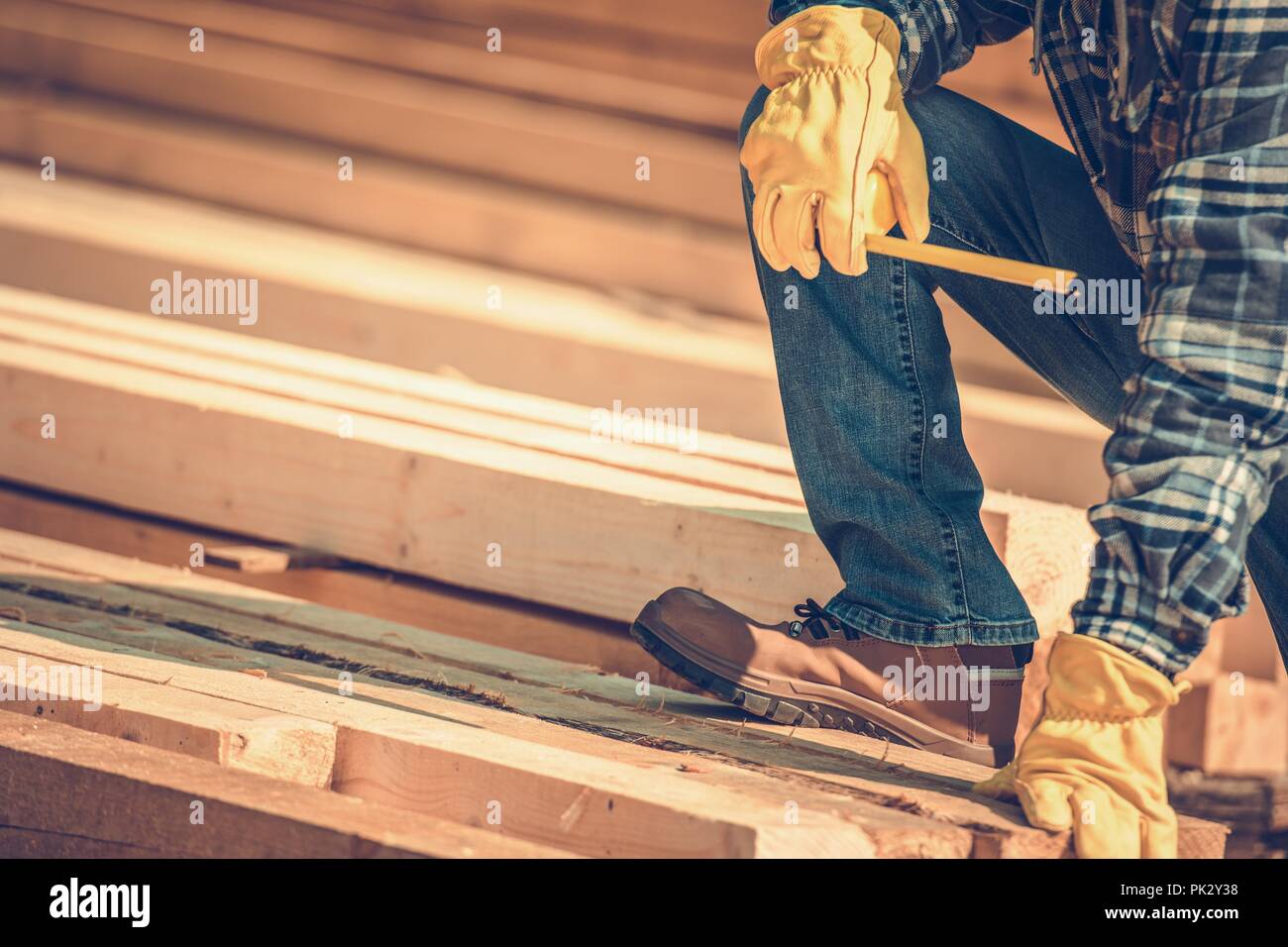 Choosing Right Construction Wood Beams by Carpenter Stock Photo - Alamy
