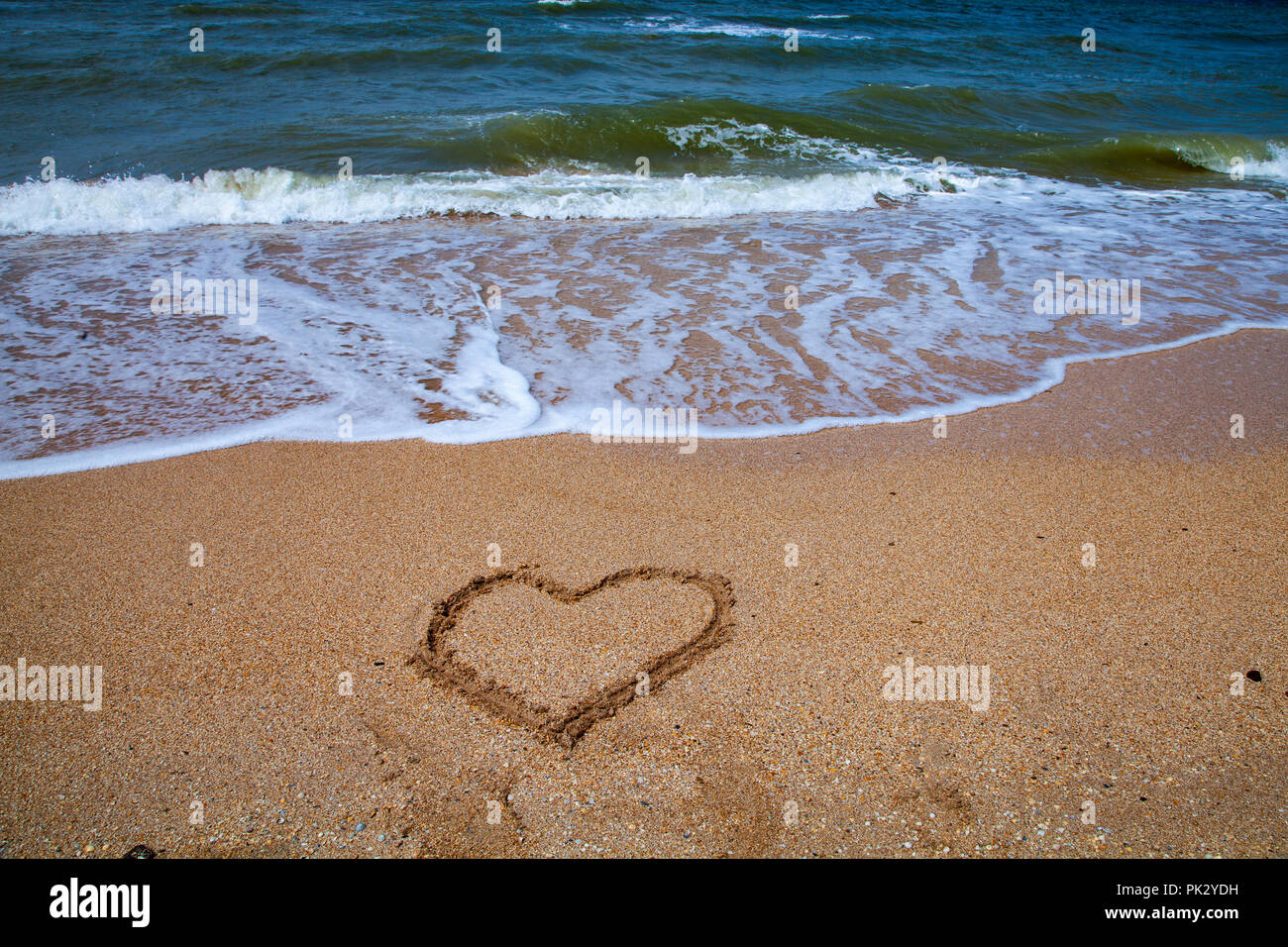 Beautiful beach and sea surf. Summer seascape. Heart in the sand and ...