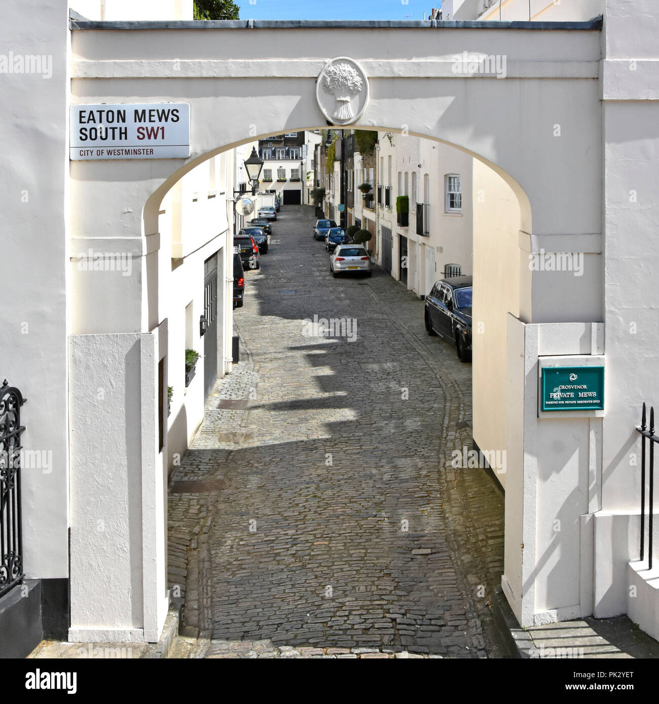 London street scene archway to narrow cobblestone mews homes with stone ...
