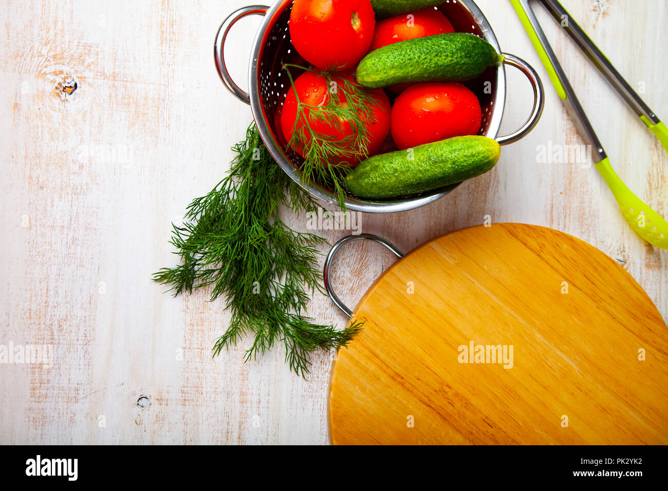 Vegetables for salad, knife and cutting board on the table. Preparation ...