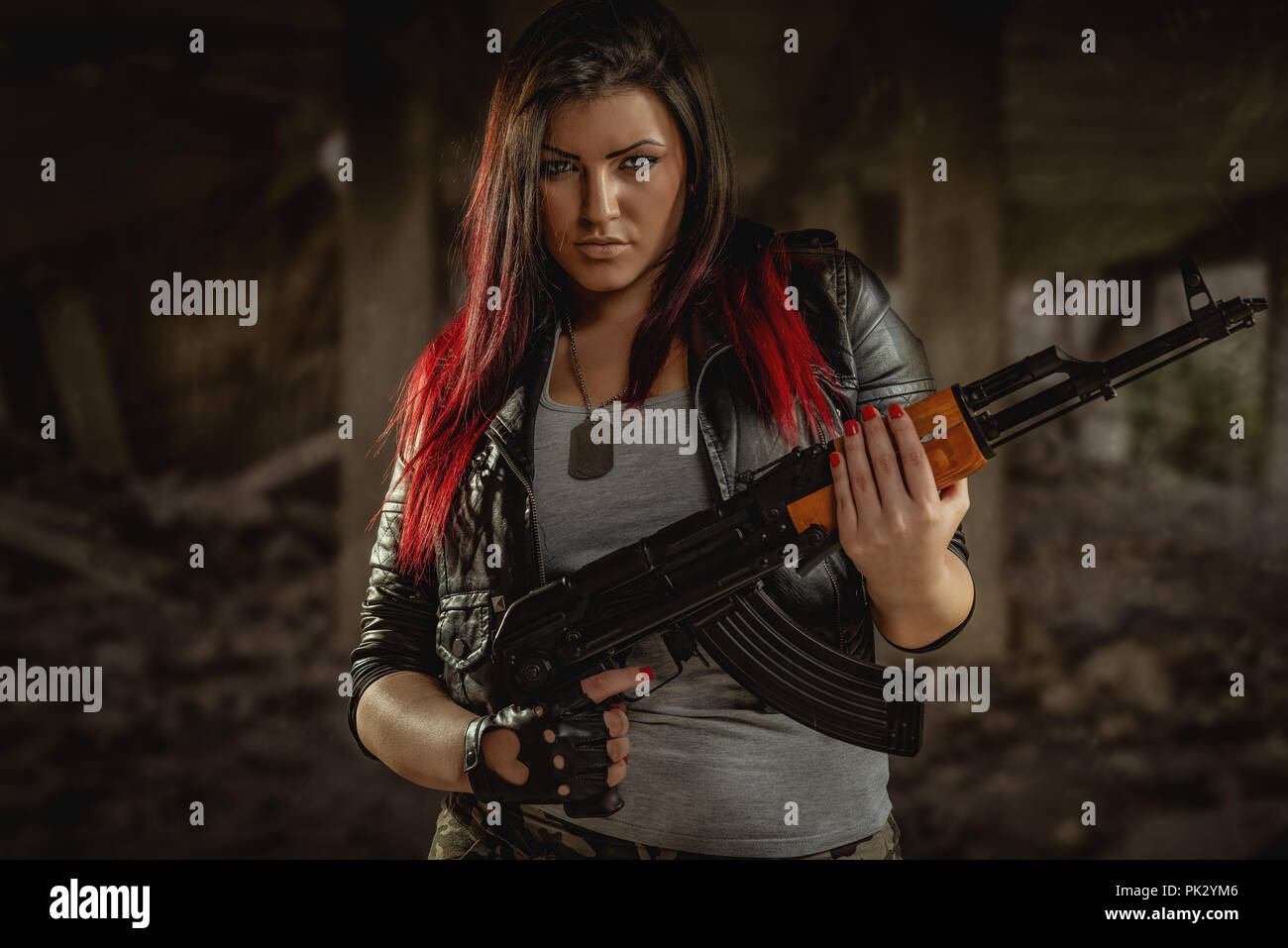 Young beautiful military woman holding rifle Stock Photo - Alamy