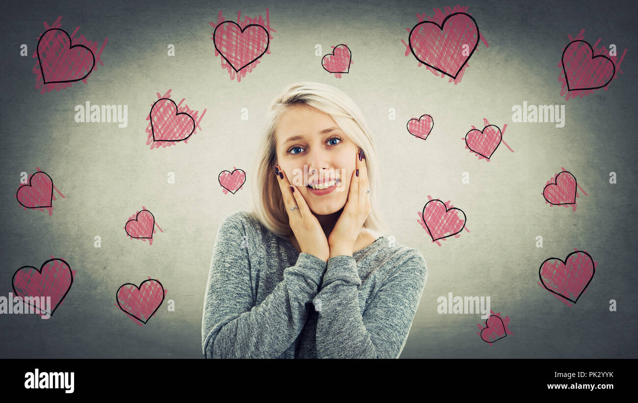 Happy beautiful girl holding her cheeks and laugh. Self love symbol as ...
