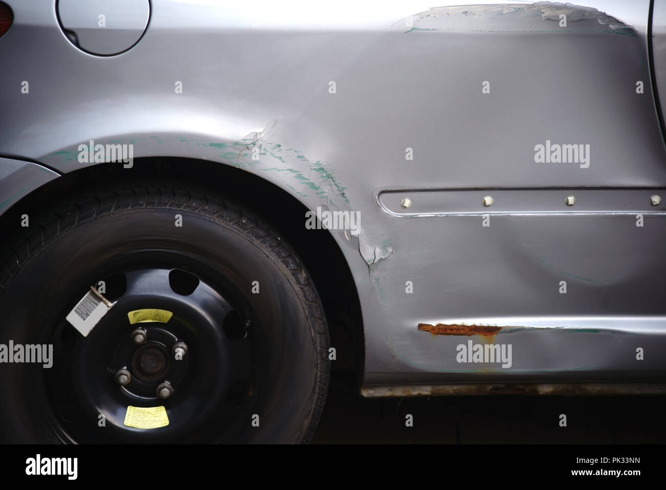 The dented and damaged side car of an automobile after an accident ...
