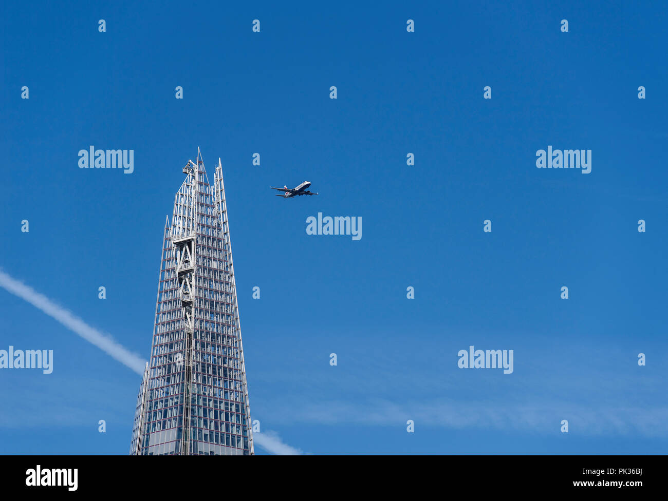 Low flying passenger plane close to the Shard on its final approach to ...