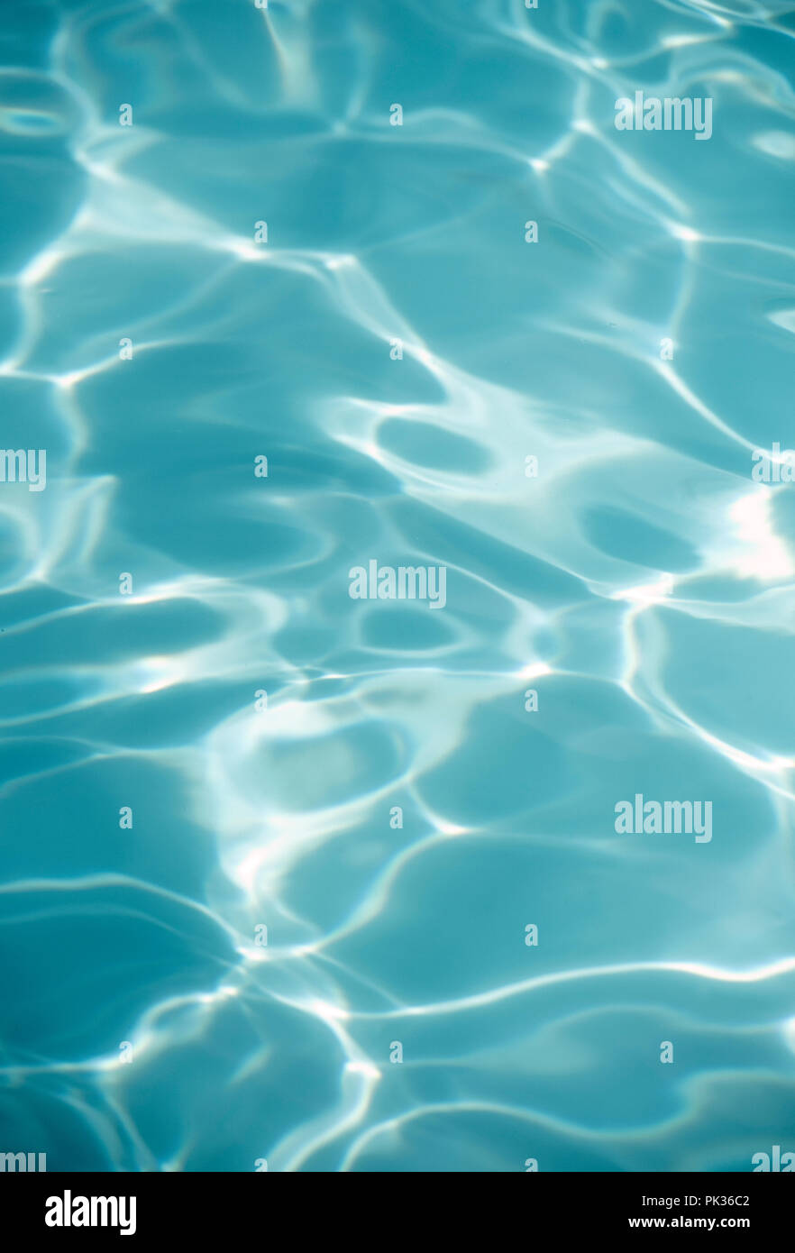 Abstract detail of sunlight reflecting off water in an outdoor swimming ...