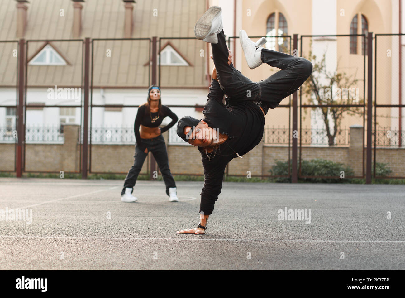 Handsome guy in a stylish black clothes dancing hip-hop. dancer ...