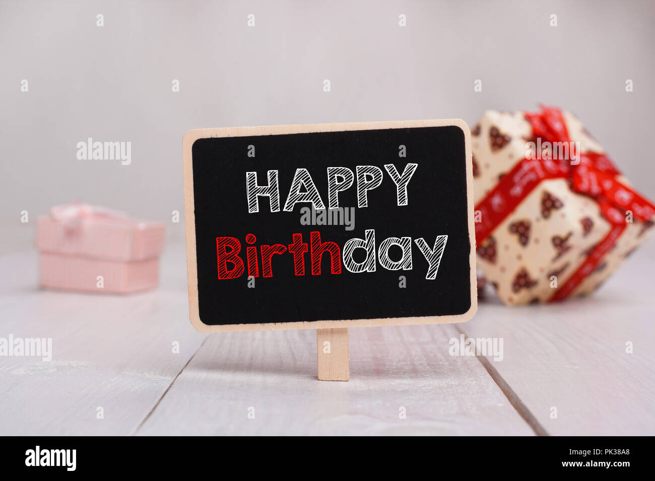 Black chalkboard with the Happy Birthday text on the table on the ...