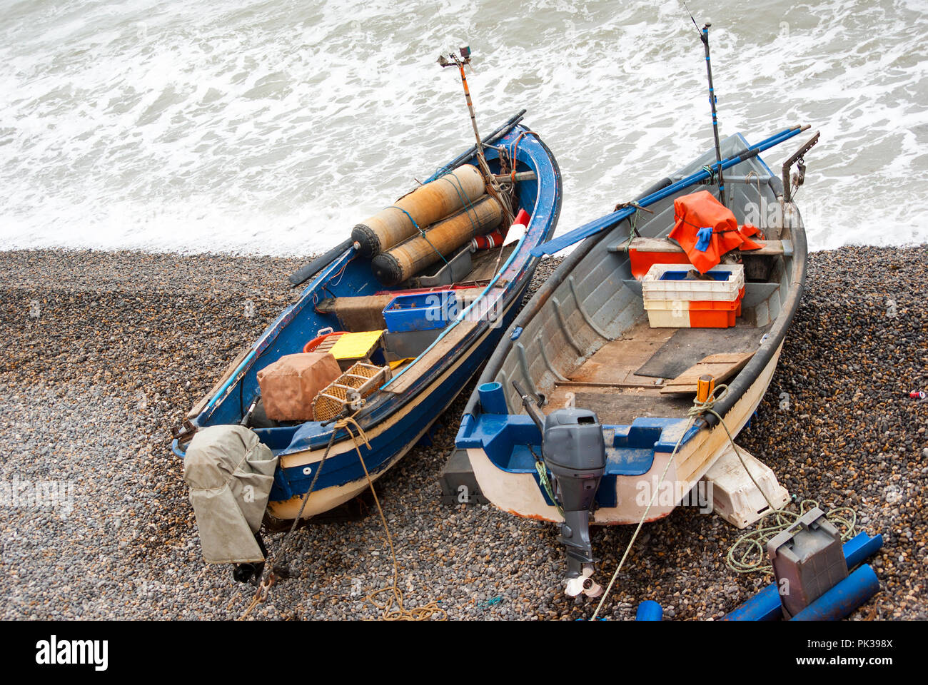 Two fishing boats on a shingle beach Stock Photo - Alamy