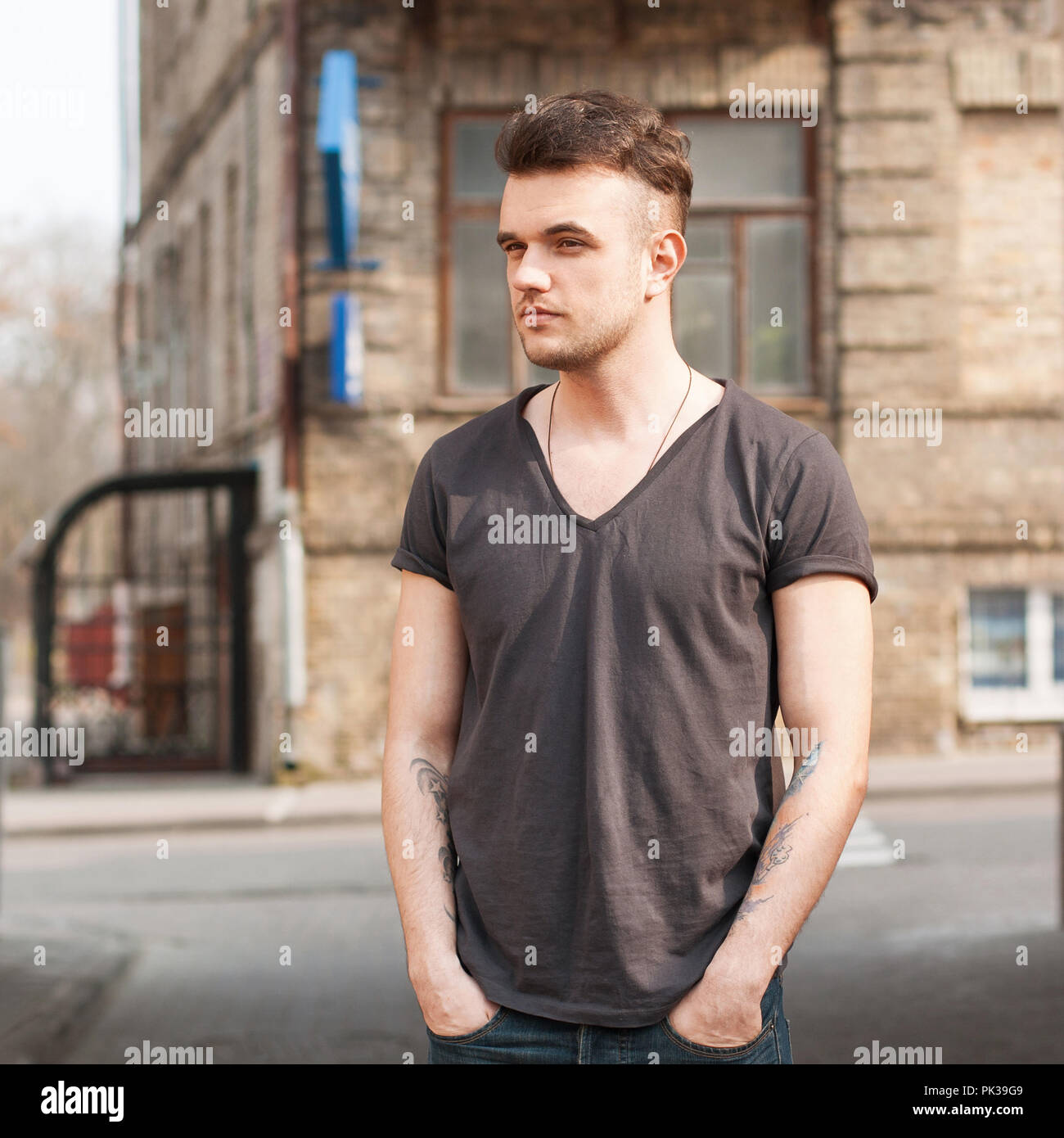 Portrait of young man standing on the street Stock Photo - Alamy