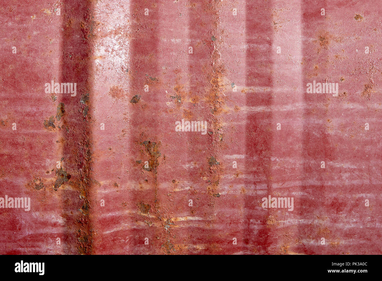 Close-up surface of the steel barrel burgundy color with signs of ...