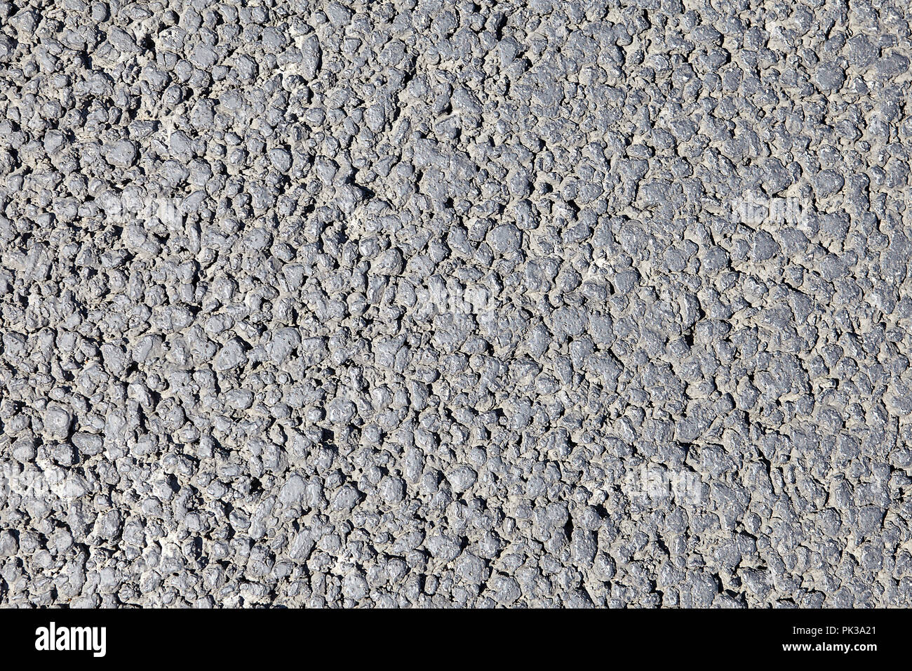 Paving bitum close up, large granules of bitumen in an asphalt road ...