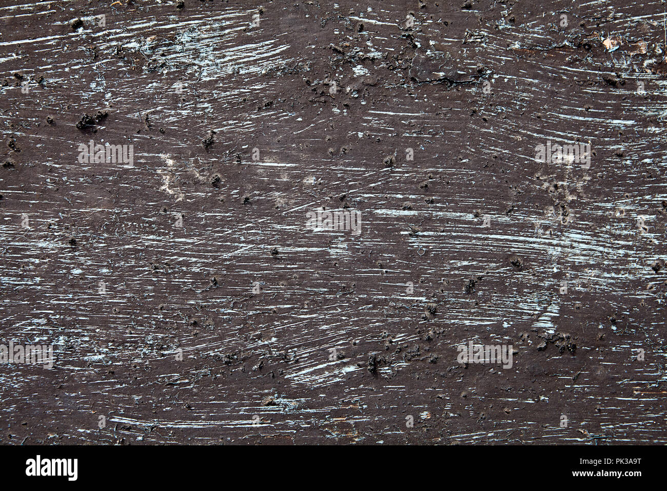 The black bottom of an inverted boat with tar impregnation, cracks ...