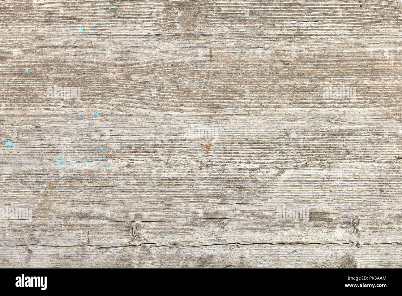 A worn, stained and scratched wooden shield of dirty beige color, a ...