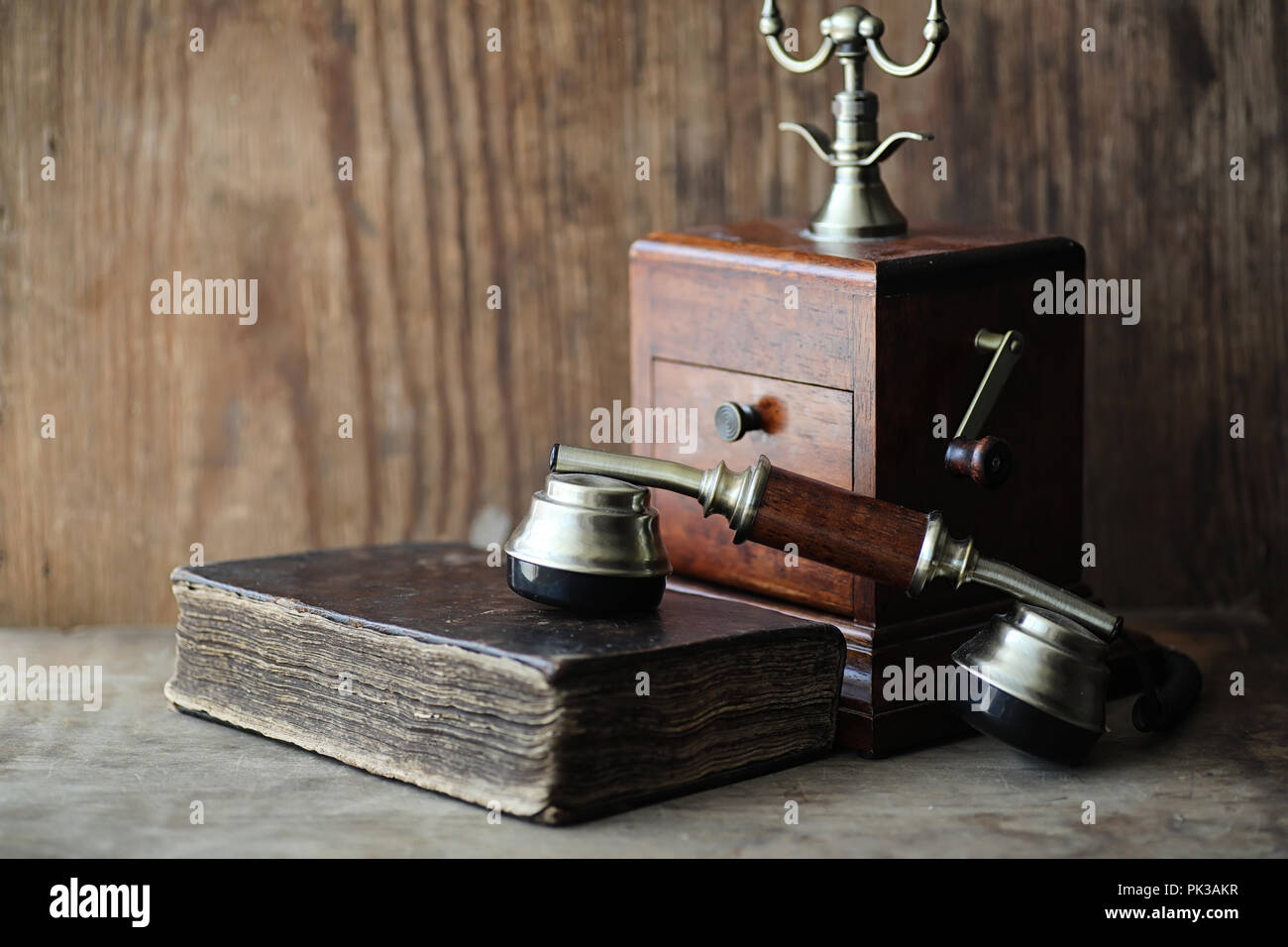 Old telephone and retro book on a wood Stock Photo - Alamy