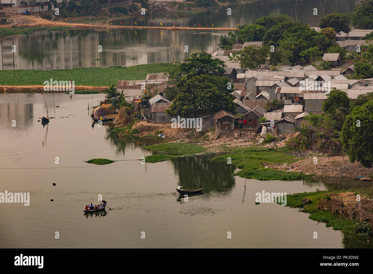 A view looking down on a slum on the banks of a river in Dhaka ...