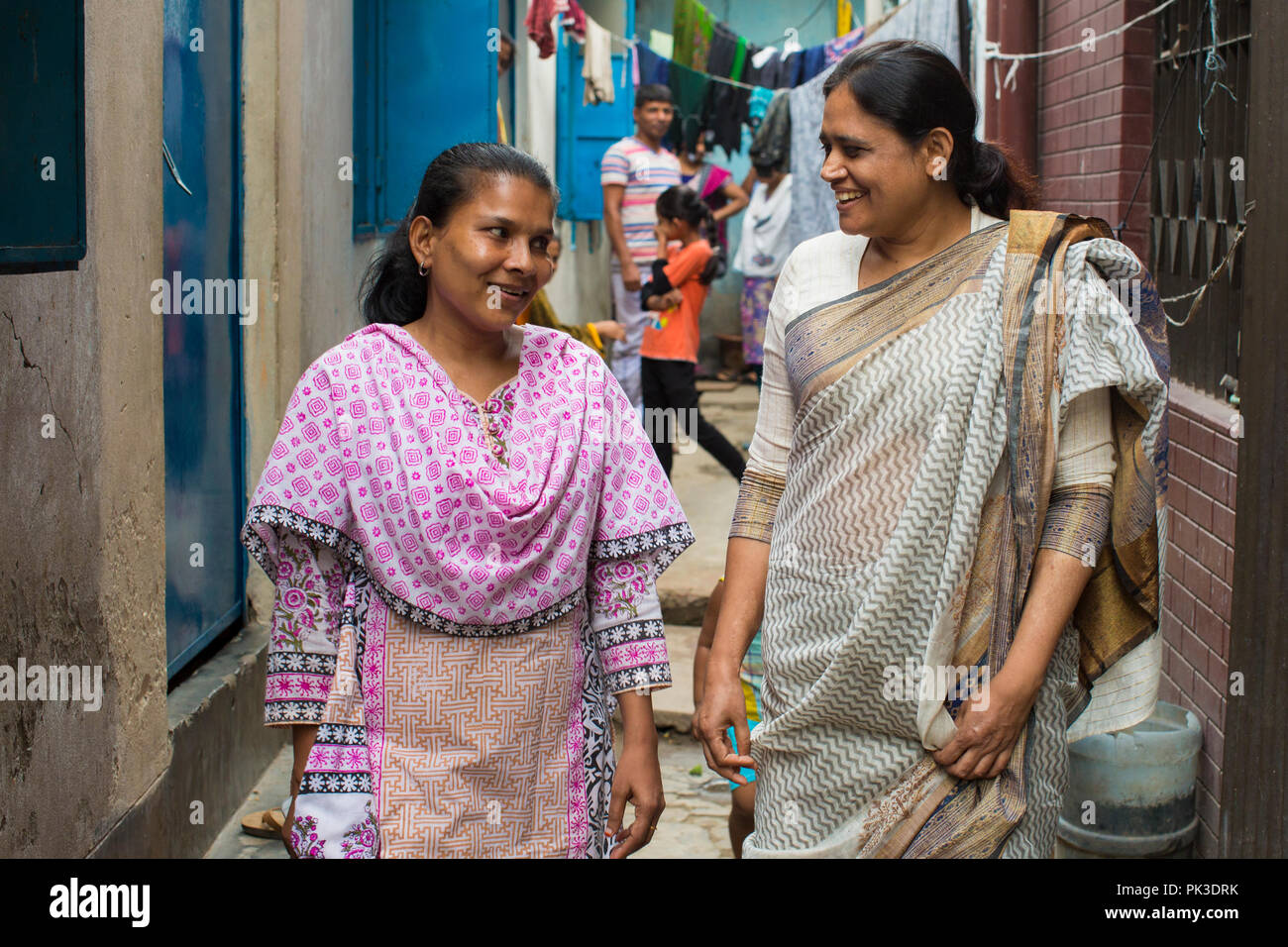 Woman visiting garment workers as part of community outreach work Stock ...