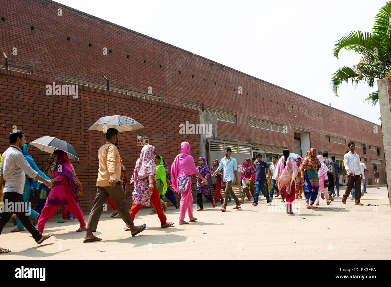 A colourful flow of garment workers walking to work in Bangladesh Stock ...