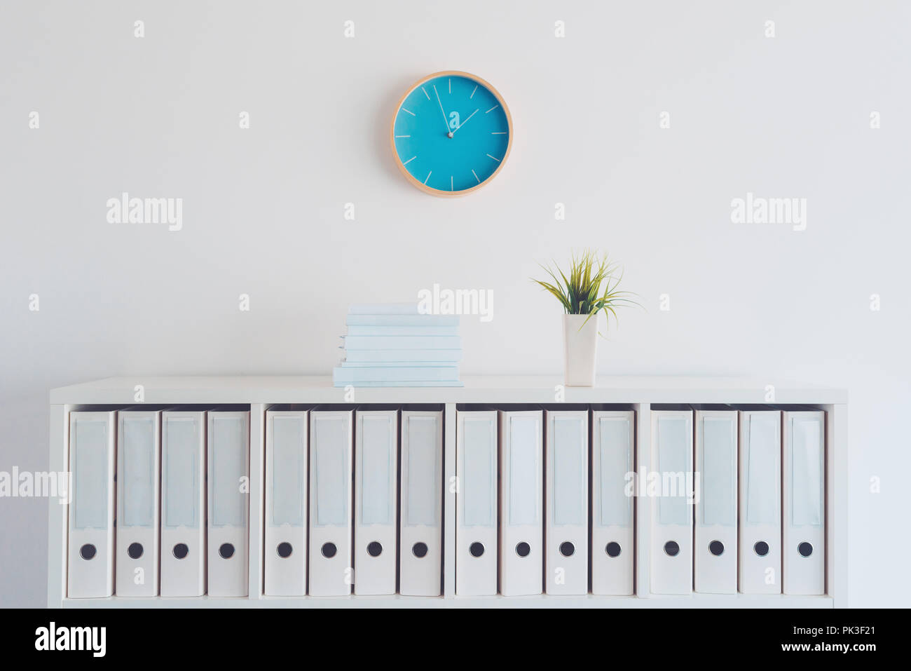 Modern bright business office interior detail depicting wall clock and ...